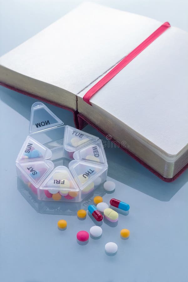 Pills Planner with Weekly Medication Capsules and Note Book Stock Image ...