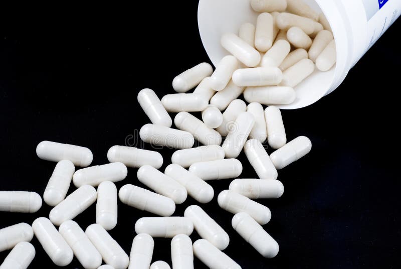 Pills spilling out of tub stock image. Image of pharmaceutical - 4980285