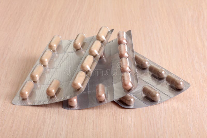 Pills on wood table stock photo. Image of pill, table - 77592490