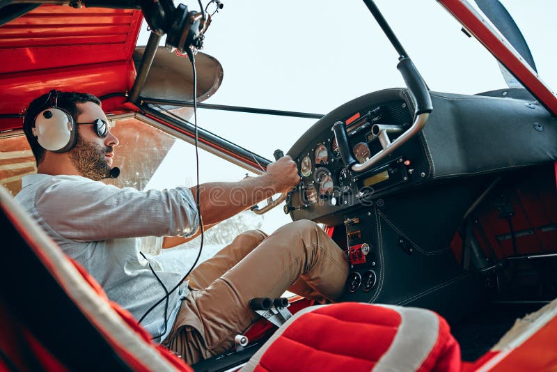Pilot in the Cabin during the Flight Stock Image - Image of headphones ...