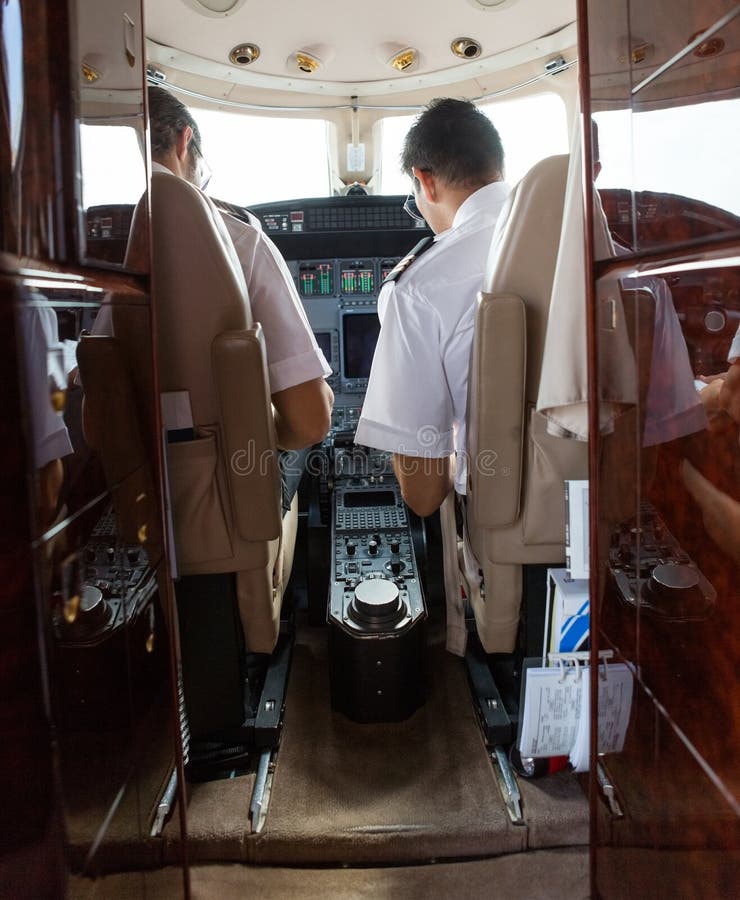 Pilot and Copilot Operating Private Jet Stock Image - Image of male ...