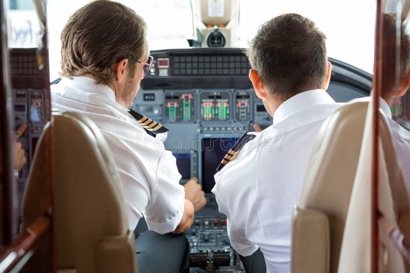Pilot And Copilot In Private Jet Cockpit Stockbild - Bild von leute ...