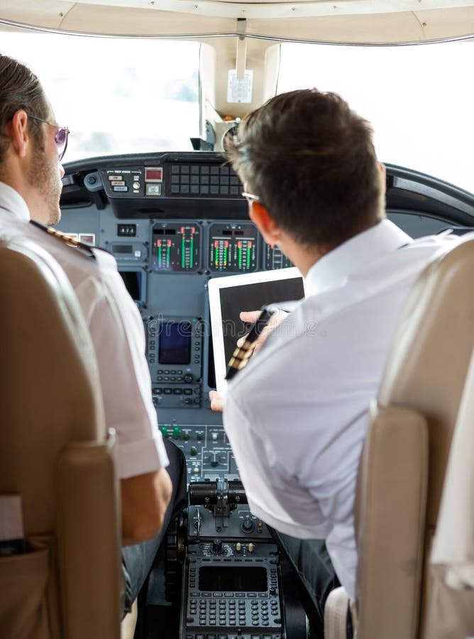 Pilot and Copilot Using Digital Tablet in Cockpit Stock Image - Image ...