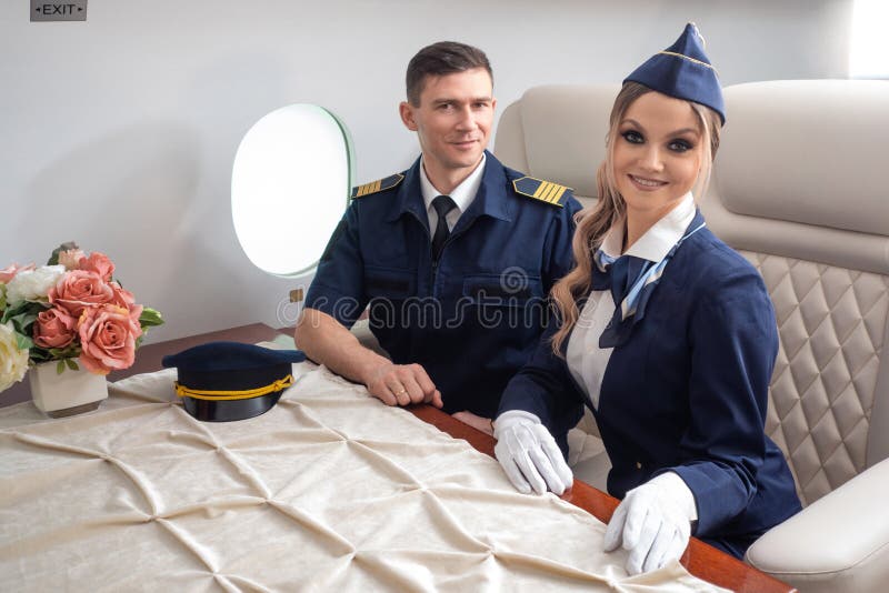 Pilot and a Flight Attendant on Board the Plane, the Cabin of a Private ...
