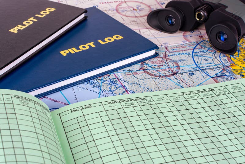 The Pilot S Flight Log Books on the Table with Maps, One is Open and ...