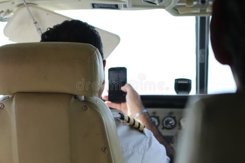 Pilot on a Smartphone stock image. Image of airport, pilot - 76862647
