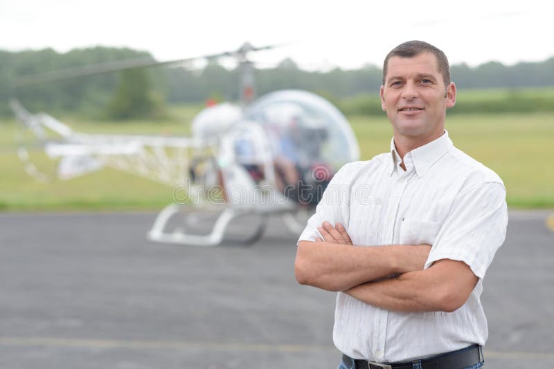 Pilot Standing Near Helicopter on Landing Point Stock Photo - Image of ...