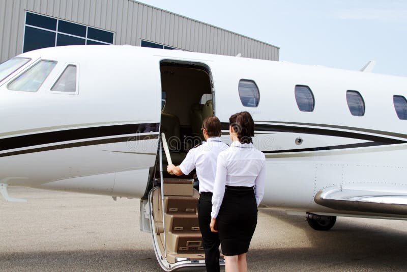 Pilot And Stewardess On Private Jet Stock Photo - Image of business ...