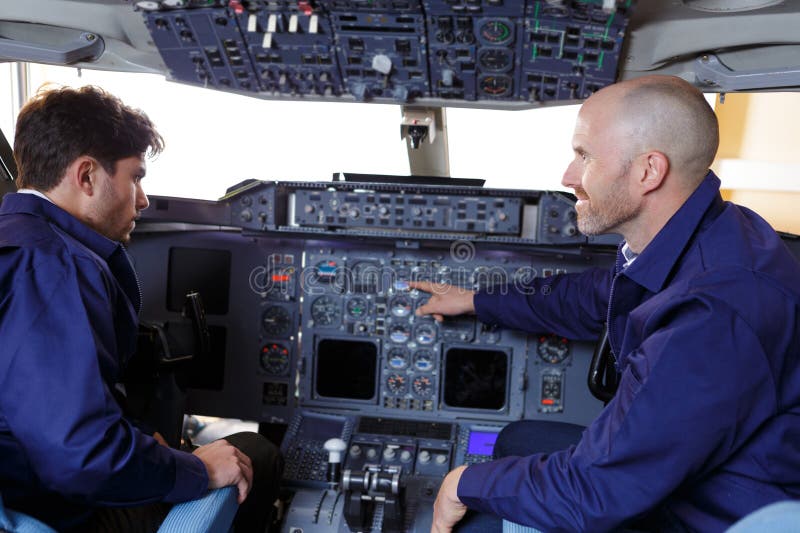 Pilot Talking with Apprentice in Cabin Stock Photo - Image of ...