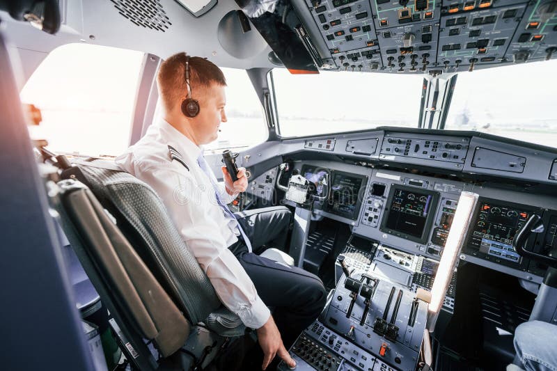 Pilot on the Work in the Passenger Airplane. Preparing for Takeoff ...