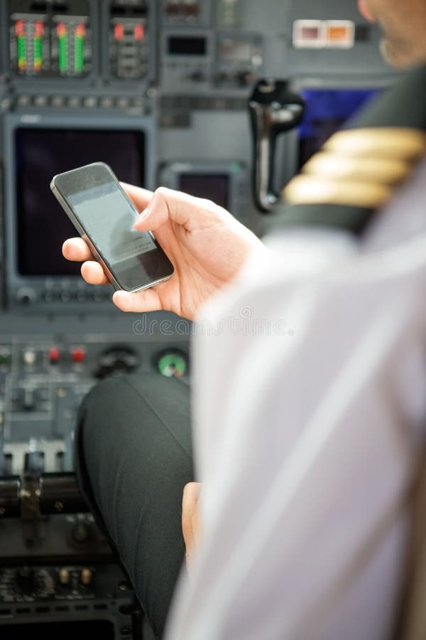 Pilots Using Smartphone in Cockpit Stock Image - Image of corporate ...