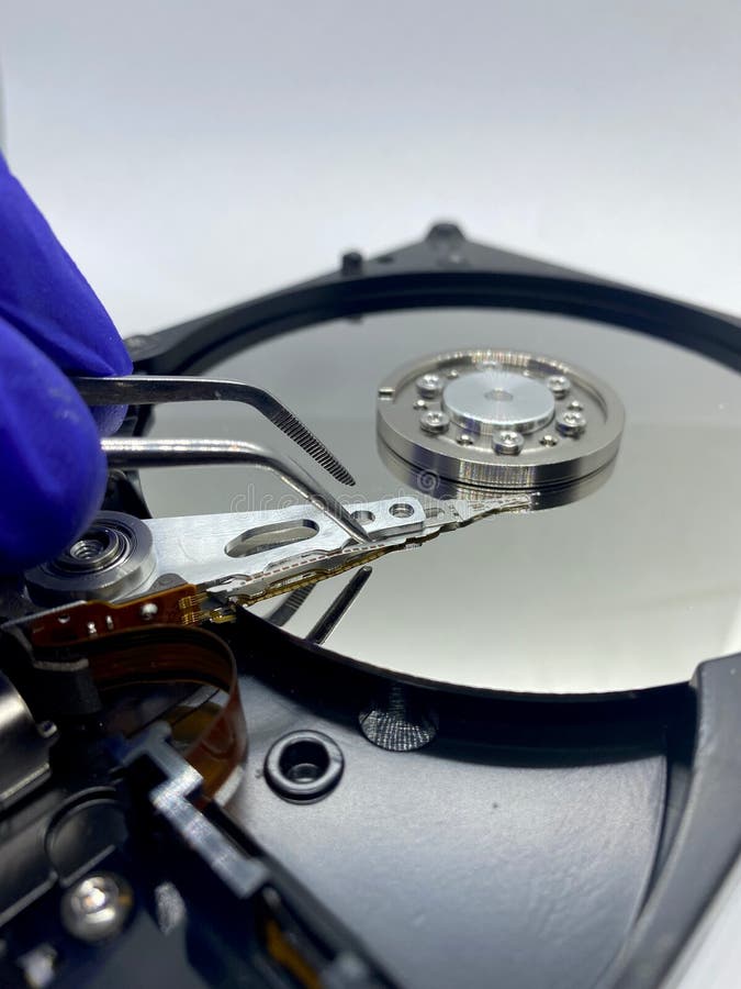 Pincer in Gloved Hand Touching a Hard Disk Plate with Reflections ...