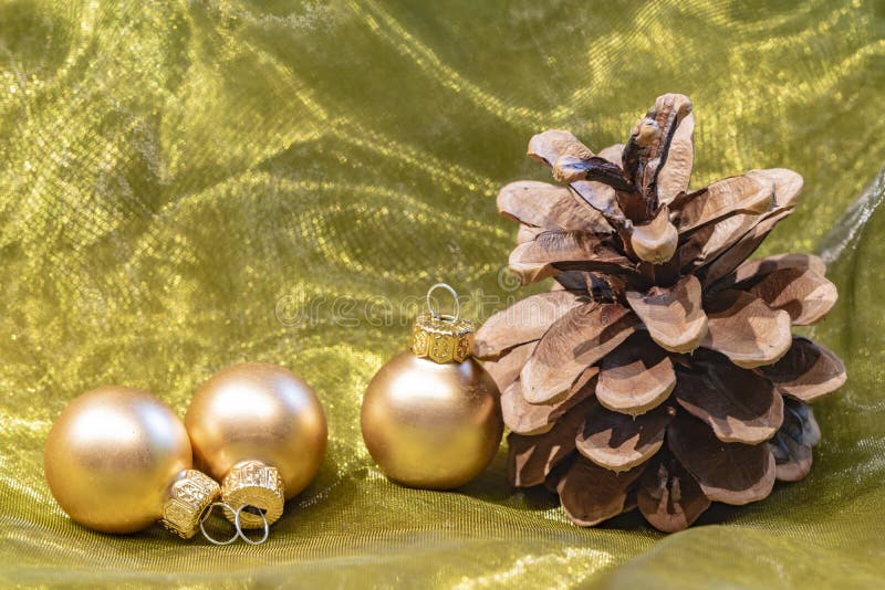 Pine Cone and Golden Christmas Tree Balls on a Colored Towel Stock ...