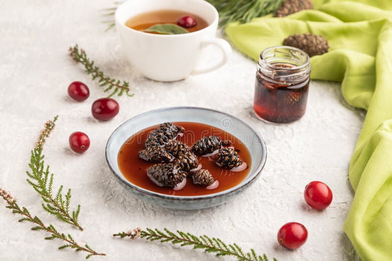 Pine Cone Jam with Herbal Tea on Gray Concrete, Side View, Selective ...