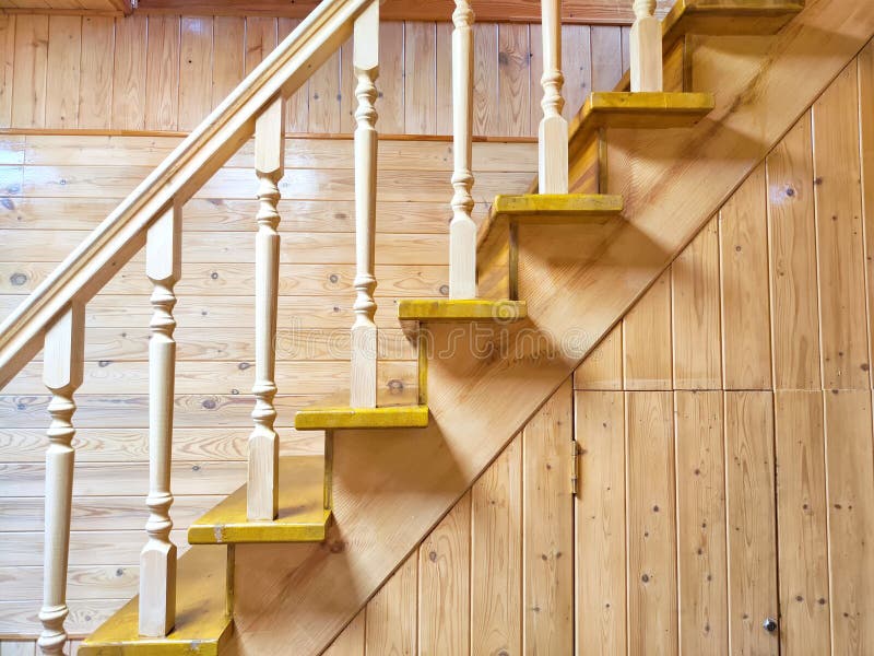 A Pine Wooden Staircase with White Balusters in a Cozy Home. Wooden ...