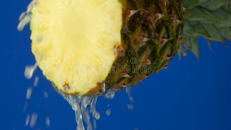Pineapple Juice Running Down the Cut of Fresh Pineapple Fruit on a Blue ...