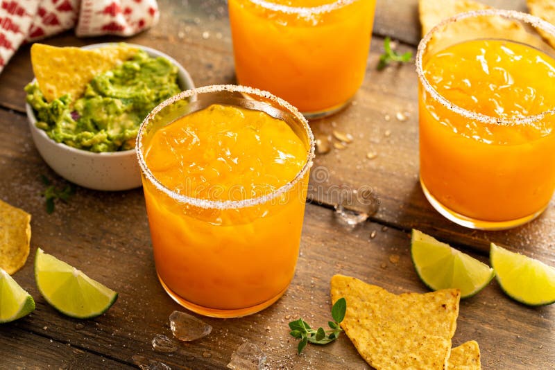 Pineapple and Mango Margarita with Chips and Guacamole Stock Photo ...