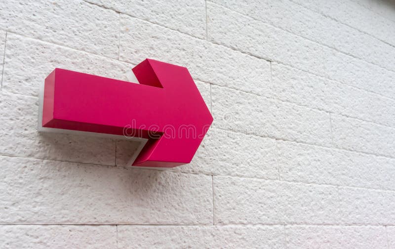 Pink Arrow Sign Hanging Against White Bricks Wall Stock Photo - Image ...