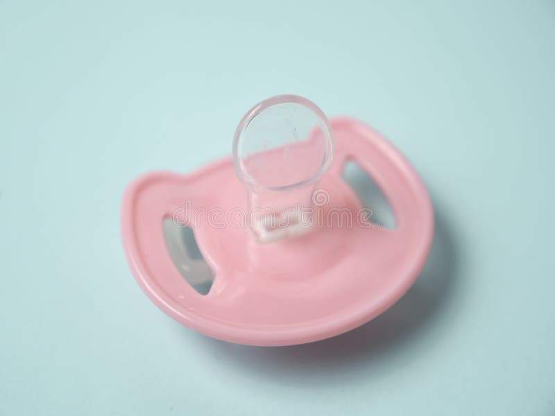 Pink baby pacifier on blue stock image. Image of infant - 300014483