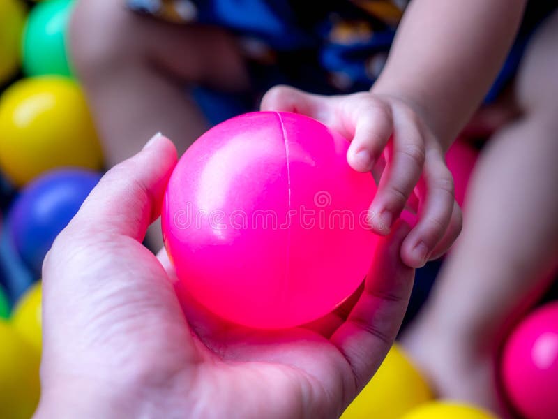 Pink Ball in the Men Sent To the Little Boy Stock Photo - Image of ...