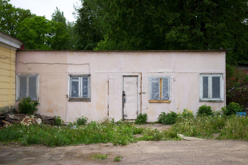 Pink Barn with Plaster on Wall Stands in the Yard. the Door is Locked ...