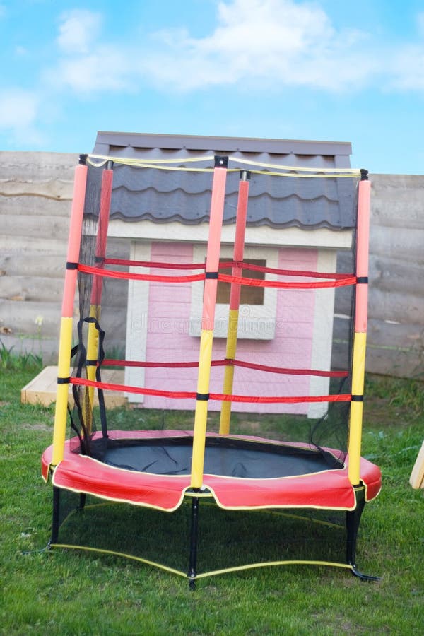 Pink Beautiful House in a Playground Trampoline with Safety Net Stock ...