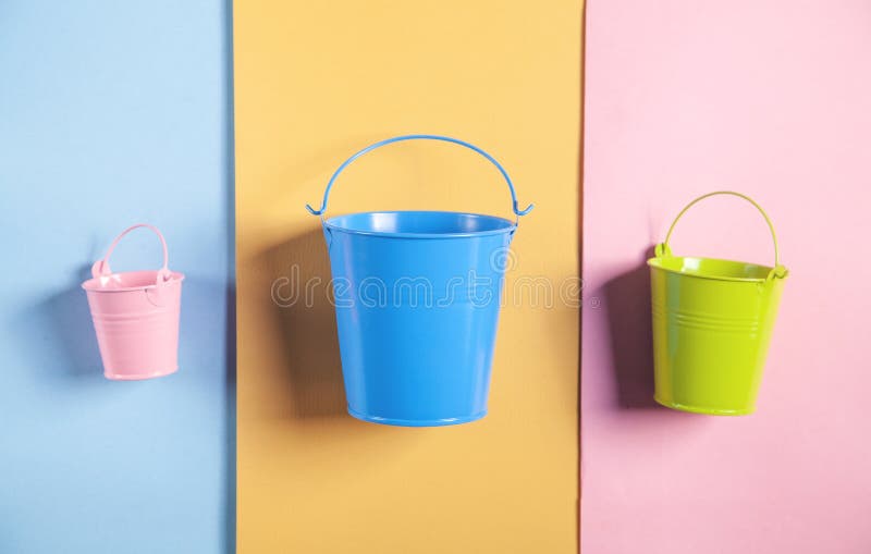Pink, Blue, Green Bucket on the Color Paper Background Stock Image ...
