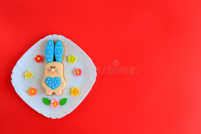 Pink and Blue Handmade Colored Gingerbread Rabbit on a White Plate on a ...