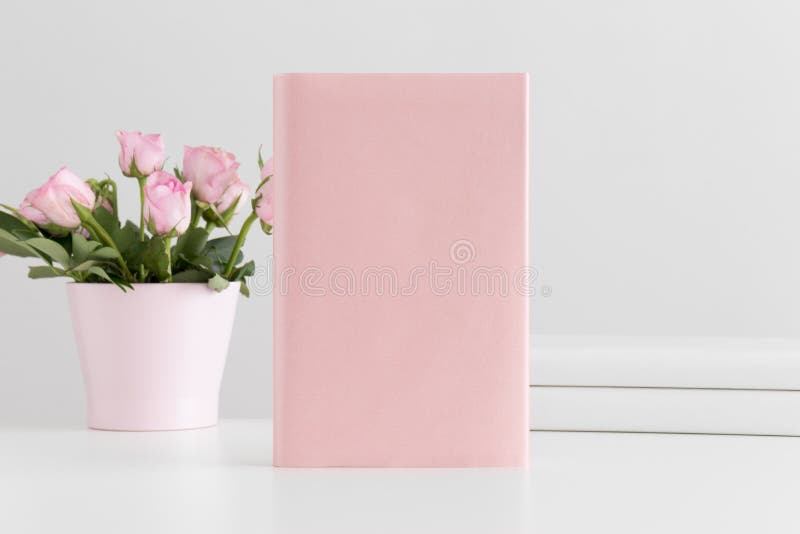 Pink Book Mockup with Books and Pink Roses in a Pot on a White Table ...