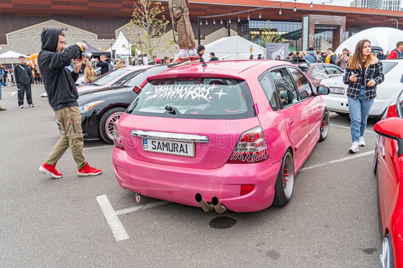 A Pink Car with Possible Modifications is Parked at a Car Event ...