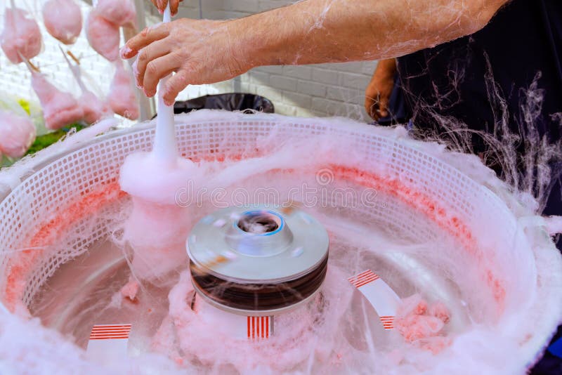 Pink Cotton Candy Being Made Outdoors Using Machine Pan for Preparing a ...
