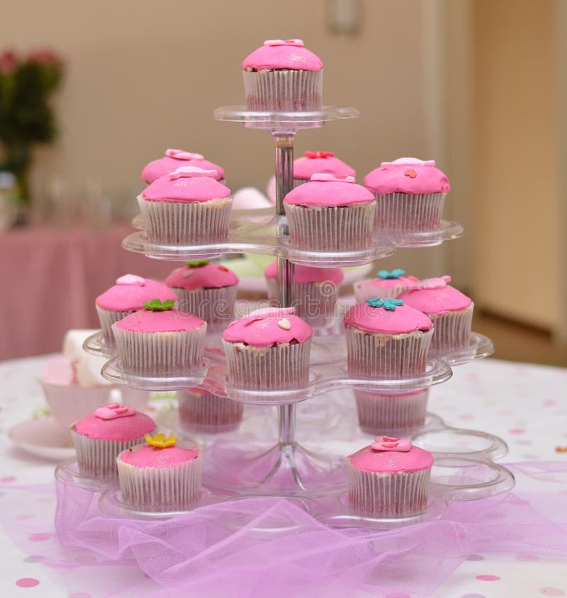 Pink cupcakes on a stand stock image. Image of icing - 67888195