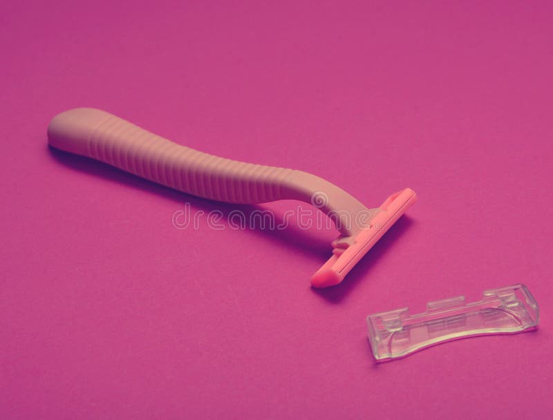 A Pink Razor for Depilation Against a Dark Concrete Wall Stock Photo ...