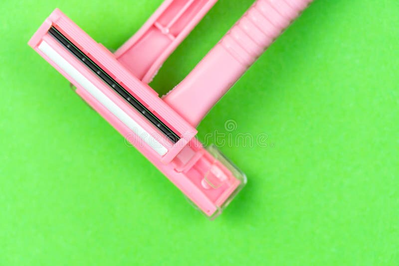 A Pink Disposable Razor on a Green . Personal Hygiene Items for Shaving ...