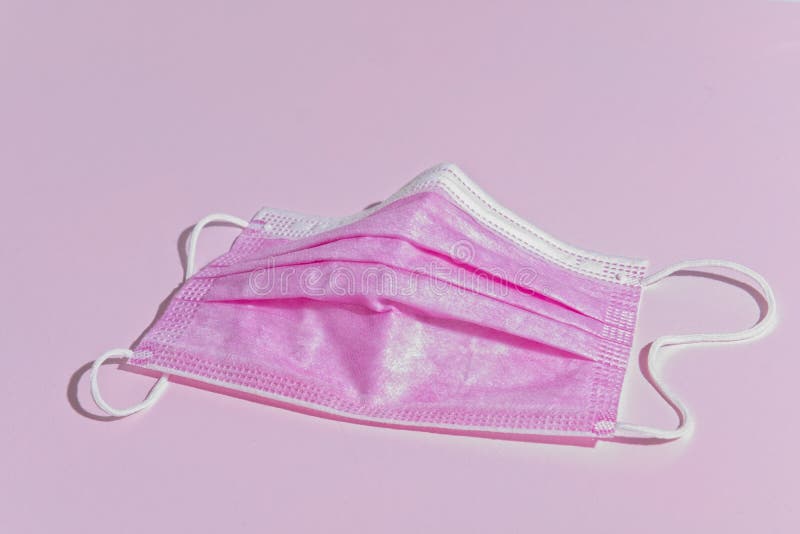 Pink Disposable Surgical Face Mask on Pink Background Stock Image ...
