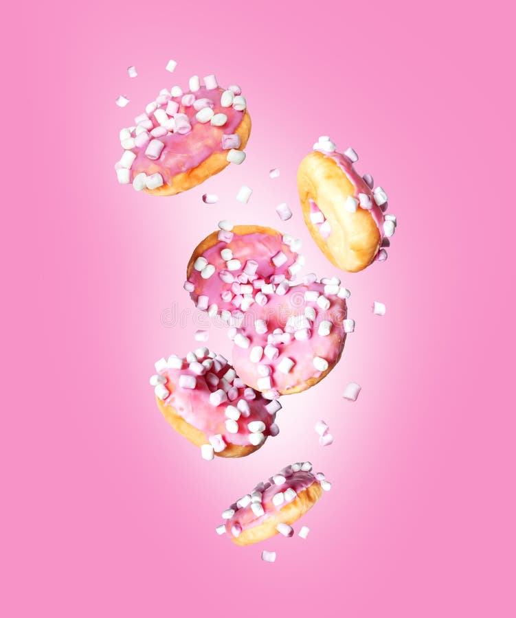 Pink Donuts with Marshmallows are Falling Down on a Pink Background ...