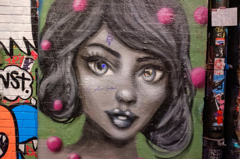 Street Art Featuring a Grayscale Portrait of a Woman with Large, Expressive Eyes and Dark Lips ...