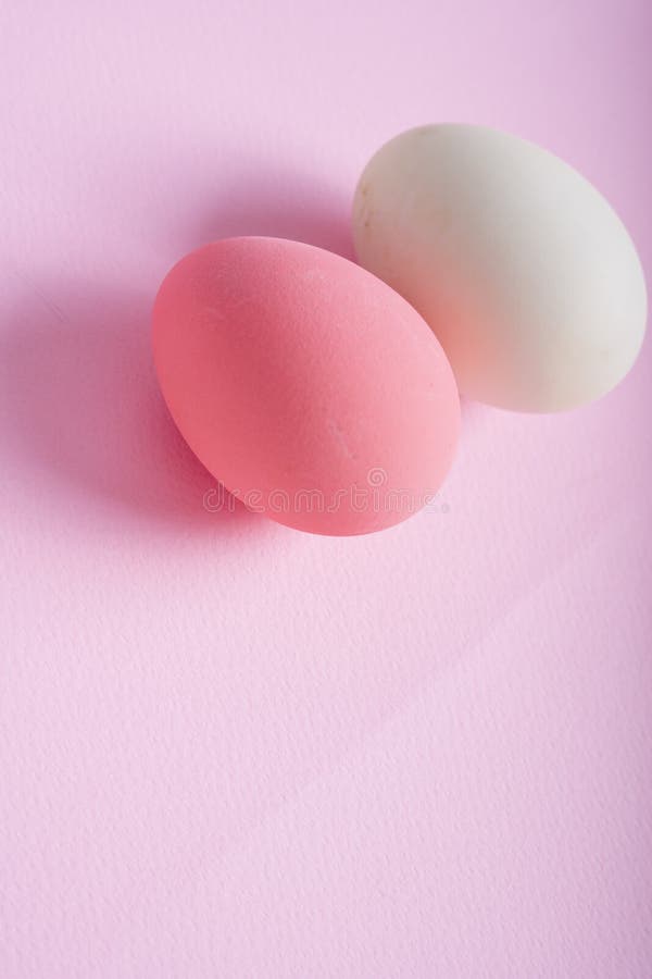 Pink Egg and White Egg Over Pink Background. Vertical Shot Stock Image ...