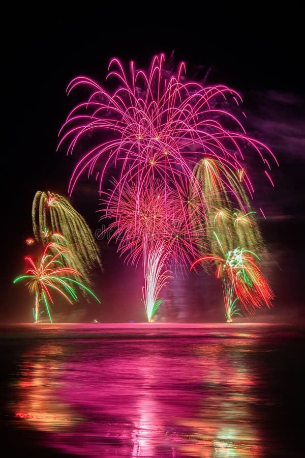 Fireworks Exploding Over the Ocean at Night Stock Photo - Image of ...