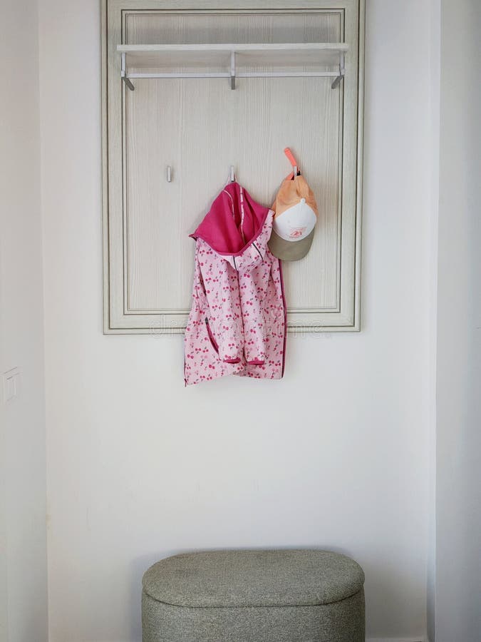 A Pink Floral-patterned Jacket and an Orange-and-white Baseball Cap ...