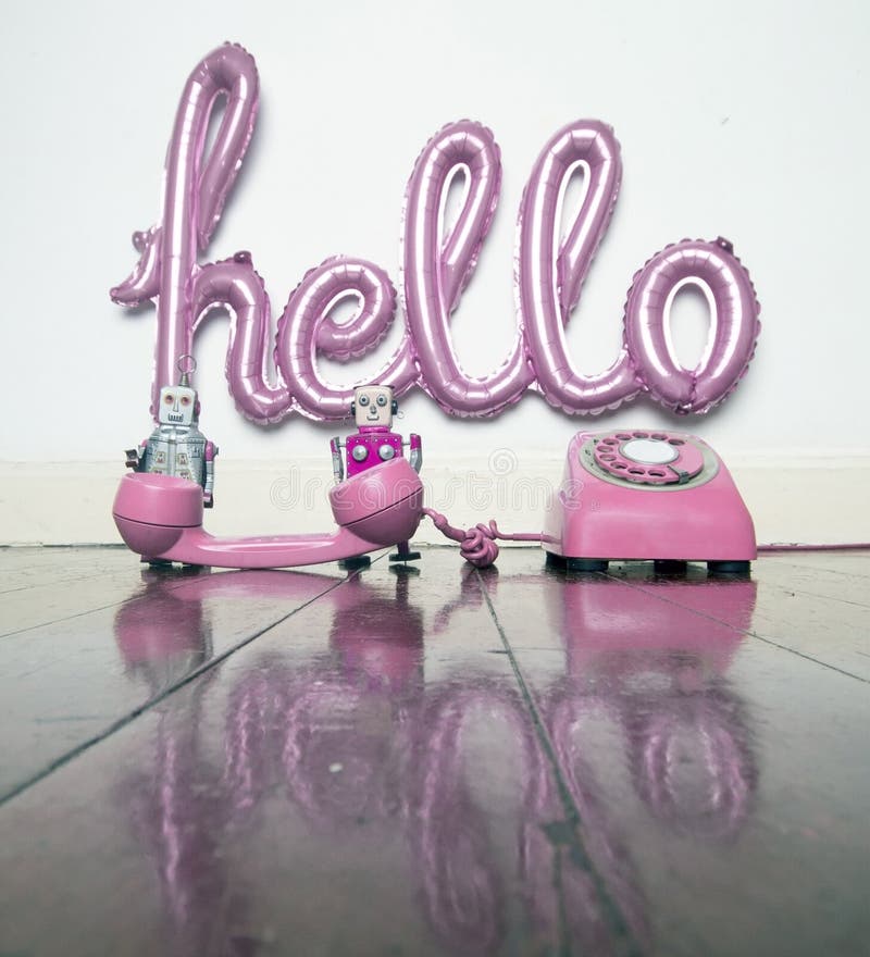 A Pink Hello Balloon and Two Robots on the Phone Stock Image - Image of ...