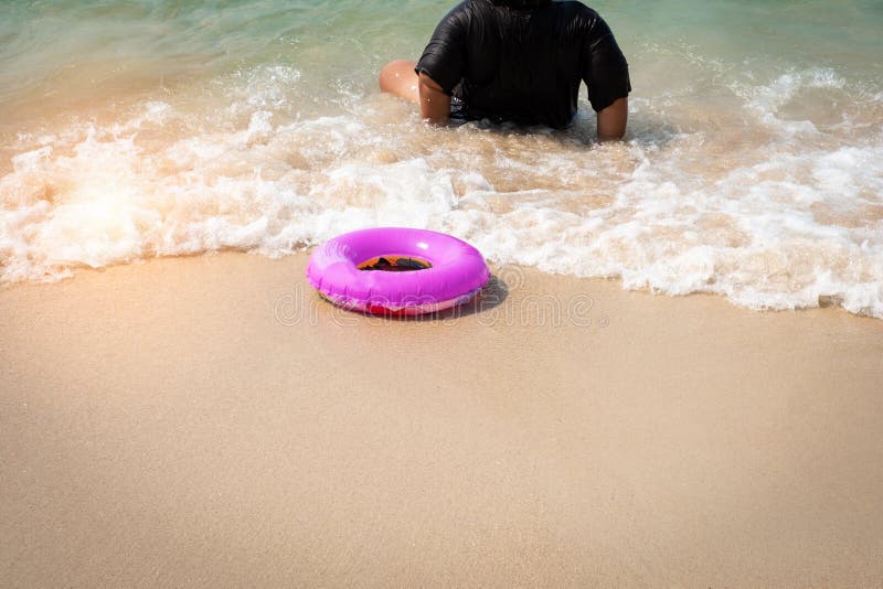 Pink Inflatable Rubber Ring on the Beach in Shallow Water Stock Photo ...