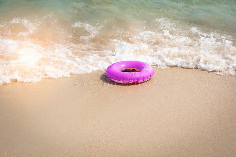 Pink Inflatable Rubber Ring on the Beach in Shallow Water Stock Photo ...