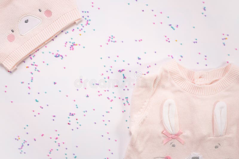 Pink Knitted Cap and Romper on White Background. Copy Space. Baby Born ...