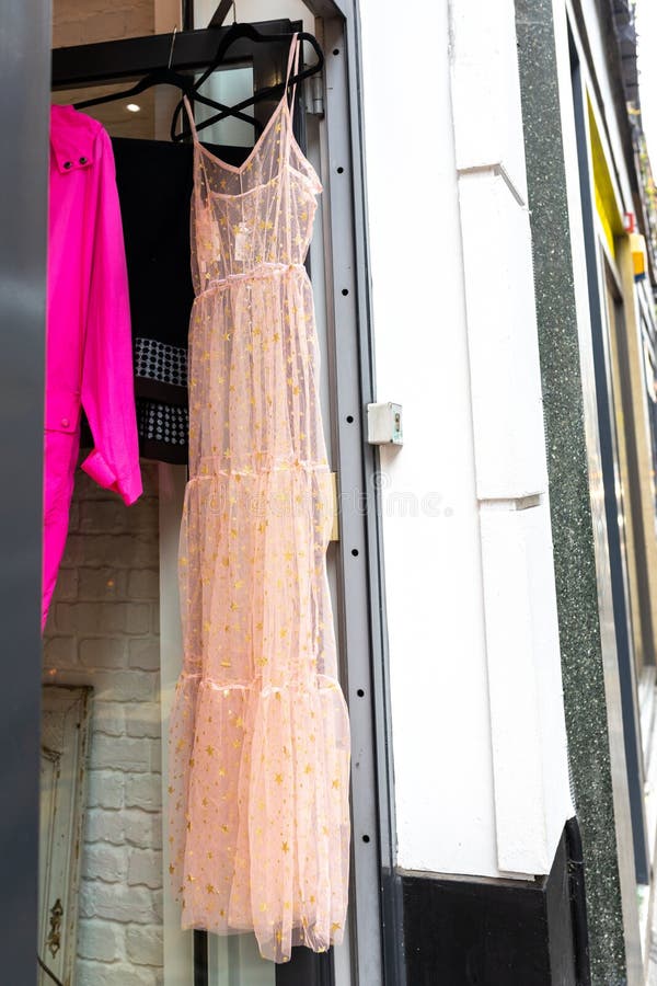 Pink Lace Dress with Straps for the Bride Hangs in the Opening of the ...