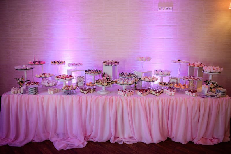 Pink Light Illuminates Dinner Table with Candy Bar Stock Image - Image ...