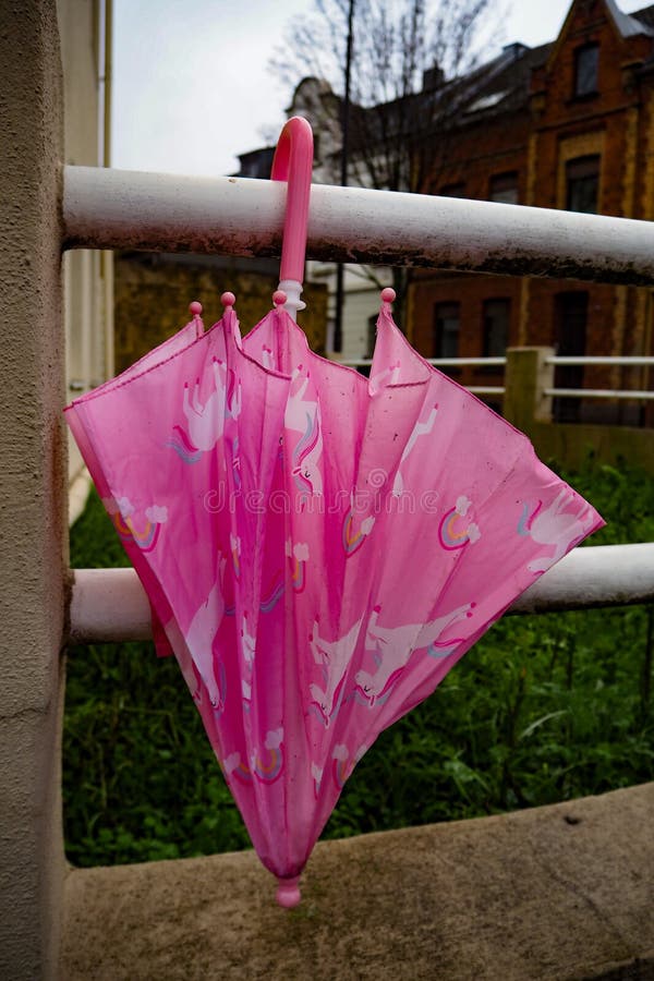 Pink Lost Umbrella Hanging on a Railing Editorial Stock Image - Image ...