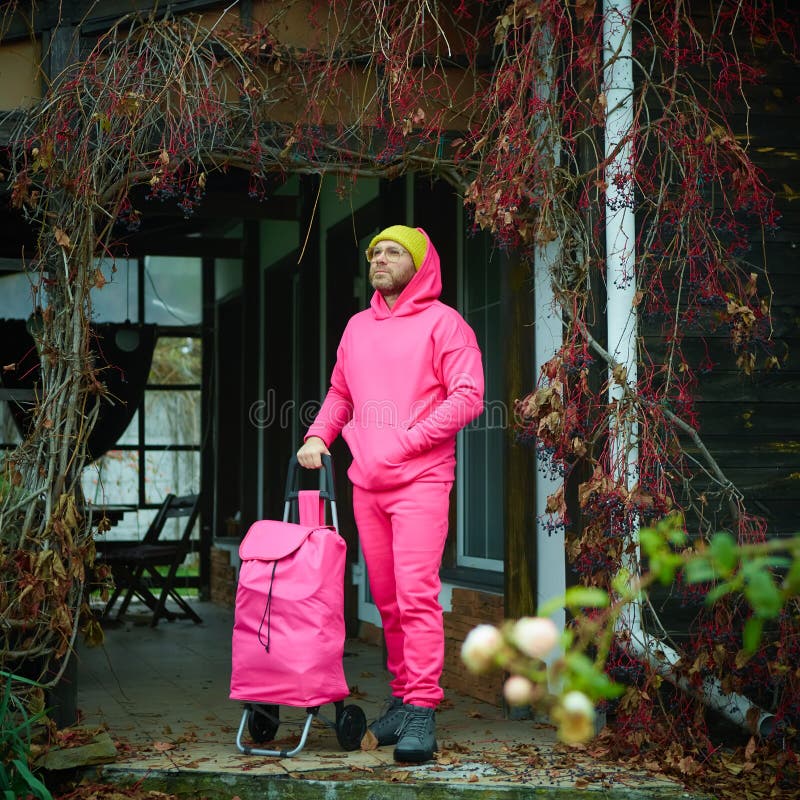 Pink Man Posing Outdoor in Pink Sport Suit with Rolling Bag. Pink Suit ...
