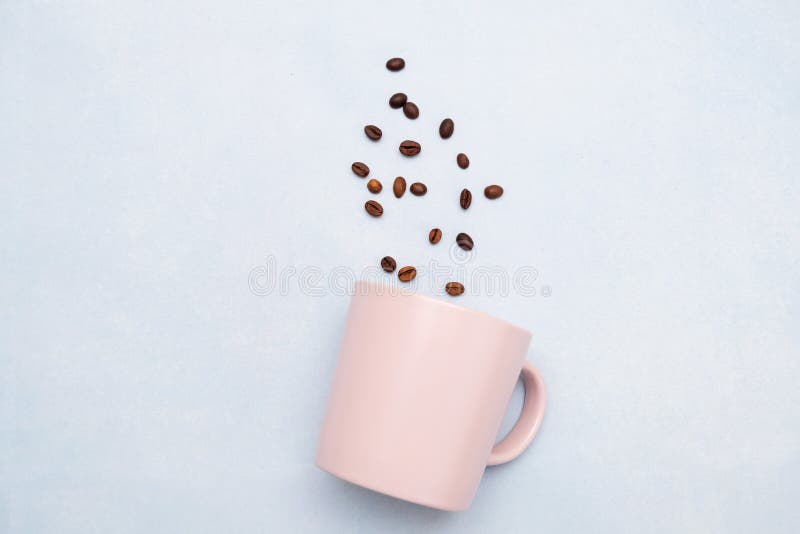 Pink Mug with Falling Coffee Beans on a Blue Background. There is Space ...