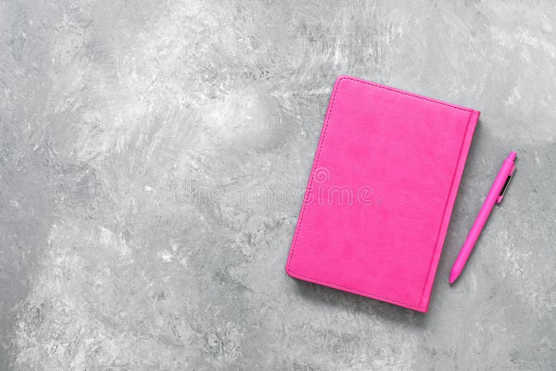 Pink Notebook and Pen on a Gray Concrete Background. Female Workspace ...